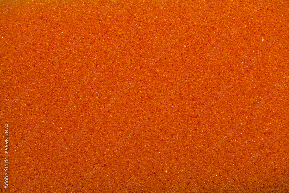 Sponge texture background. Close-up of orange bath sponge with porous ...