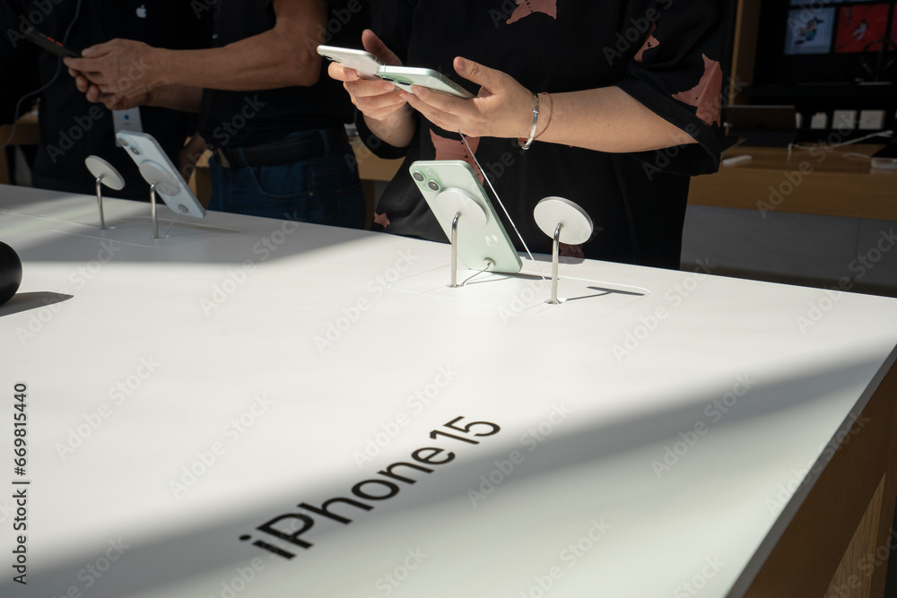 Shanghai, China - Oct 23, 2023: A shopper compares the new iPhone 15 ...