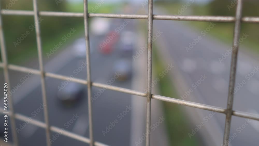 Blurred moving traffic on British motorway with view through in-focus ...