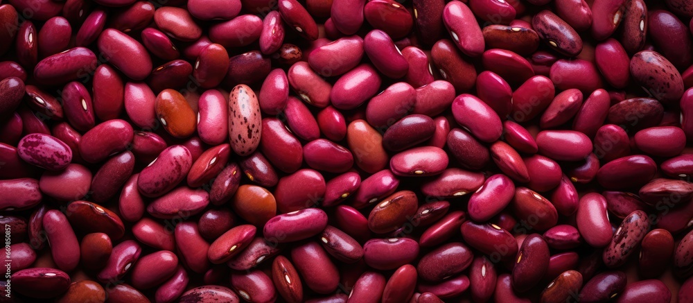 The high resolution photo depicts red and pink beans on a brown ...