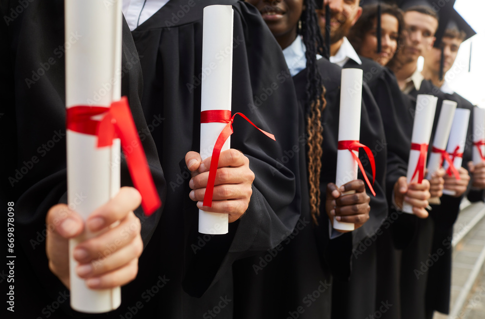 University students with diplomas in hands. Group of young people ...
