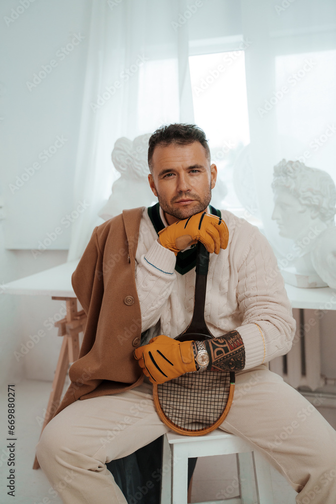 A dapper model in old money style, sitting among ancient Greek ...