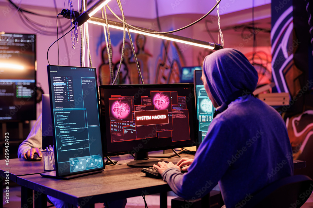 Criminal in hood successfully hacking into computer system in abandoned ... Criminal in hood successfully hacking into computer system in abandoned ...