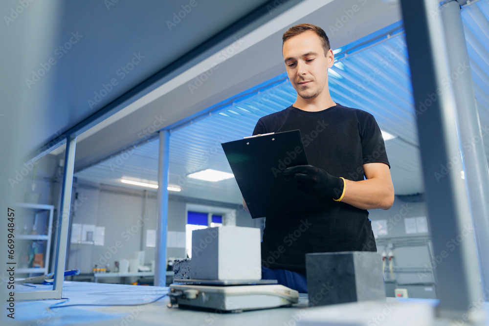 Engineer measures size and controls quality of concrete cube in ...