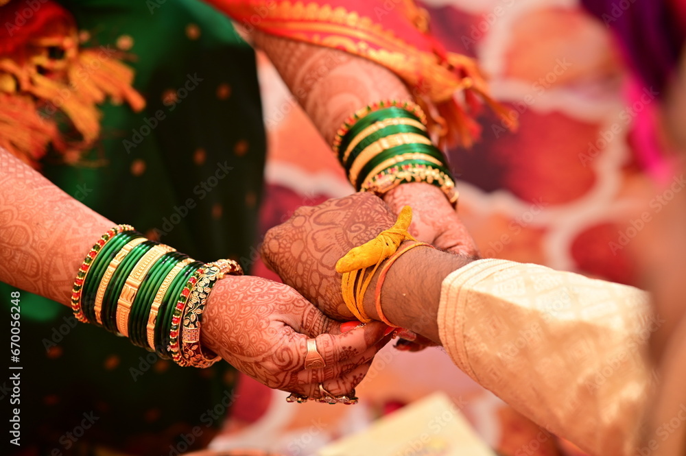 Indian groom Tie a Turmeric Thread on bride hand. Hands of bride and ...