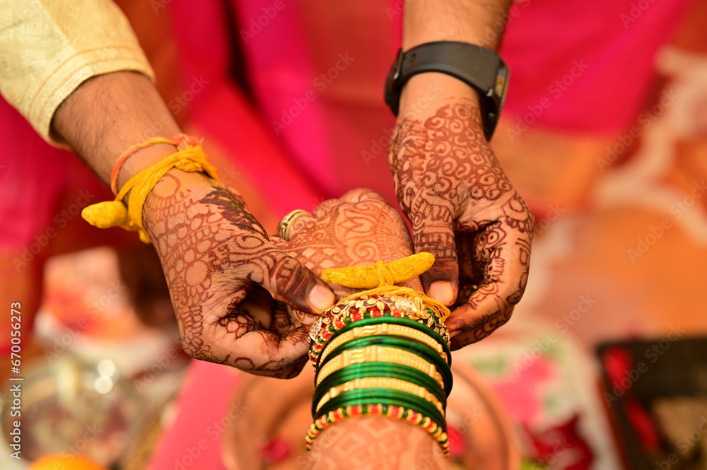 Indian bride Tie a Turmeric Thread on hand of groom. Hands of bride and ...