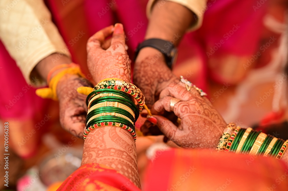 Indian bride Tie a Turmeric Thread on hand of groom. Close Up Hands of ...