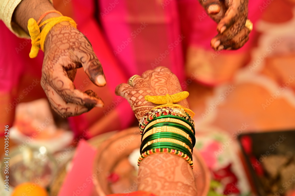 Indian bride Tie a Turmeric Thread on hand of groom. Close Up Hands of ...
