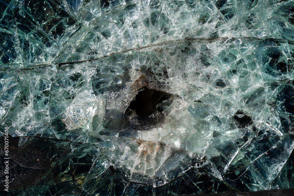 Bullet hole in armor-piercing glass. Armor piercing glass of damaged ...