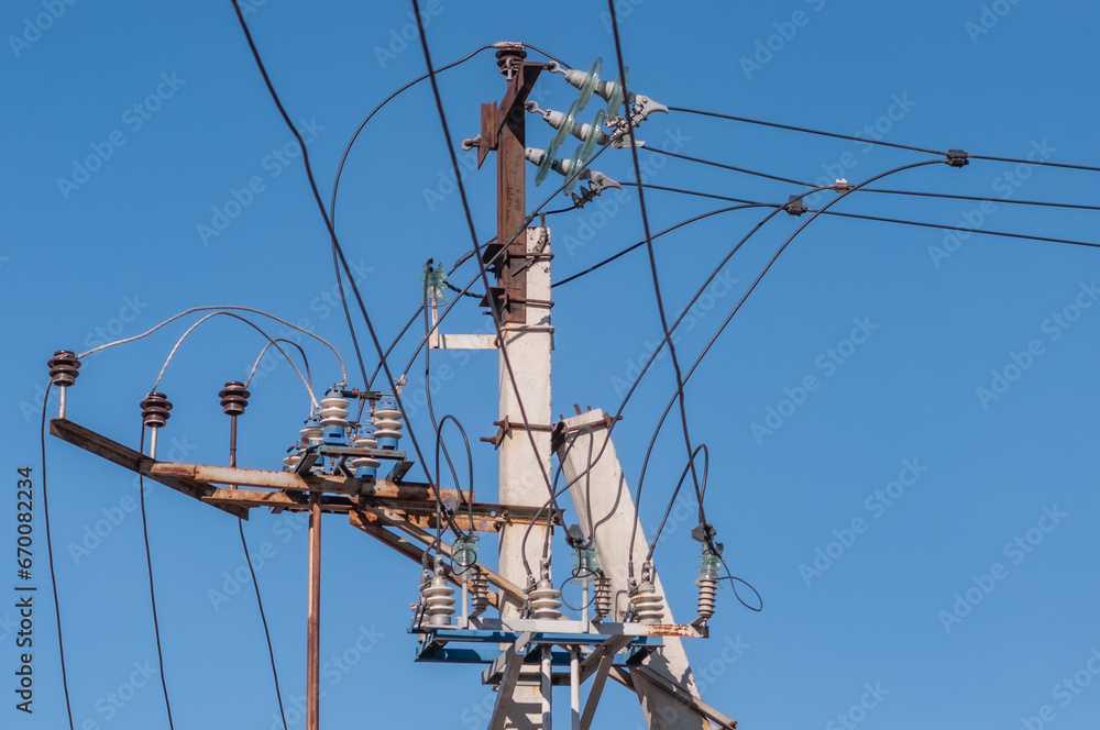 Overhead power line on a pole with a manual three-phase disconnector ...