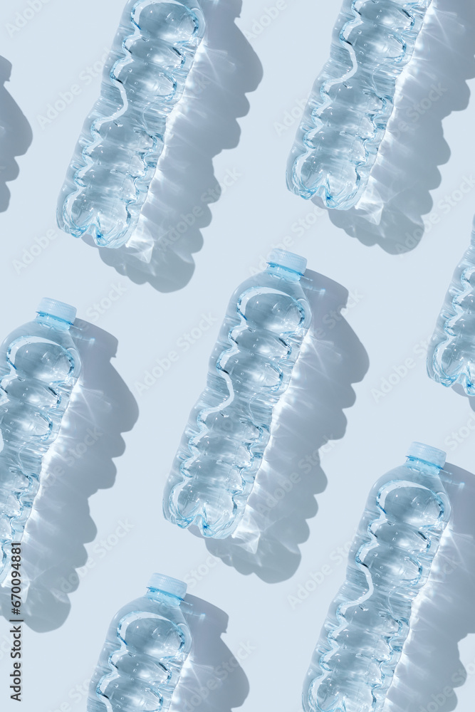 Minimal Pattern Plastic bottles water at sunlight with shadow on blue ...
