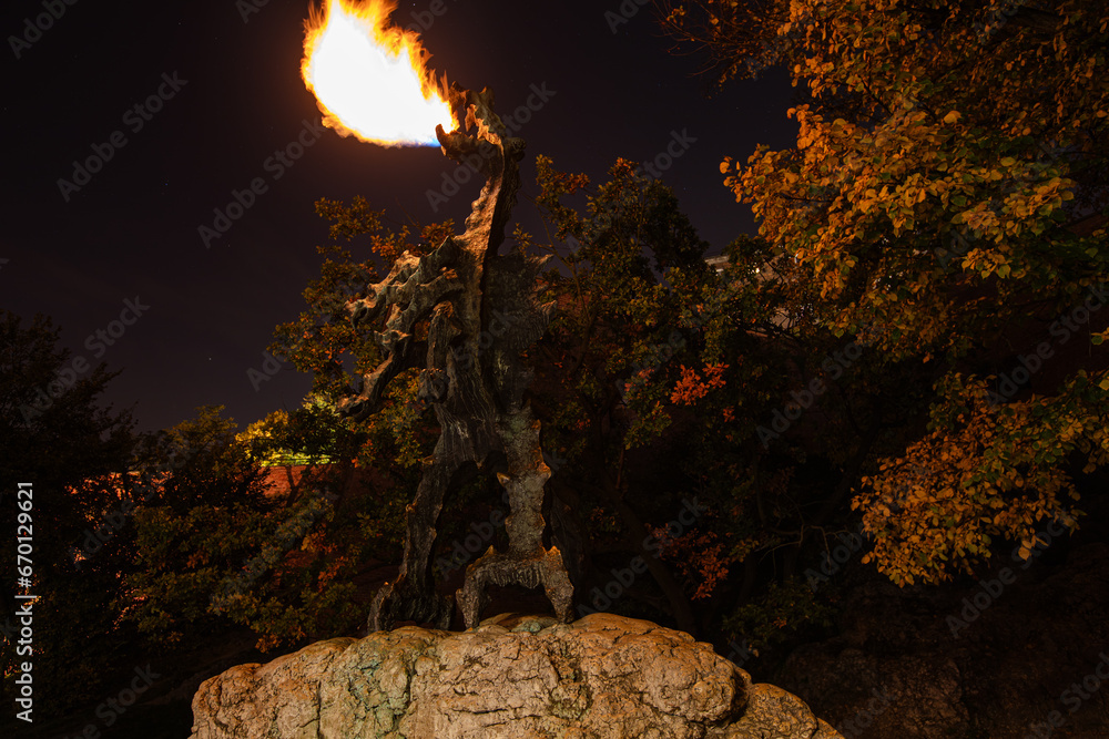 Wawel Dragon Statue breathing fire at the foot of the Wawel Hill. The ...