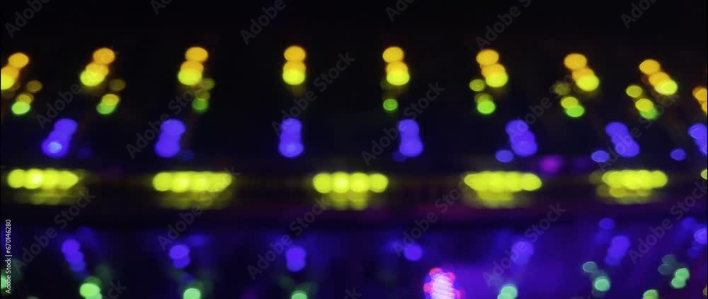 Moving lights in blur. Bokeh lights go on and off alternately, creating a movement of light ...