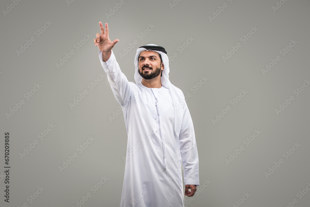 Arabian man wearing traditional emirati dishdasha kandura in studio ...