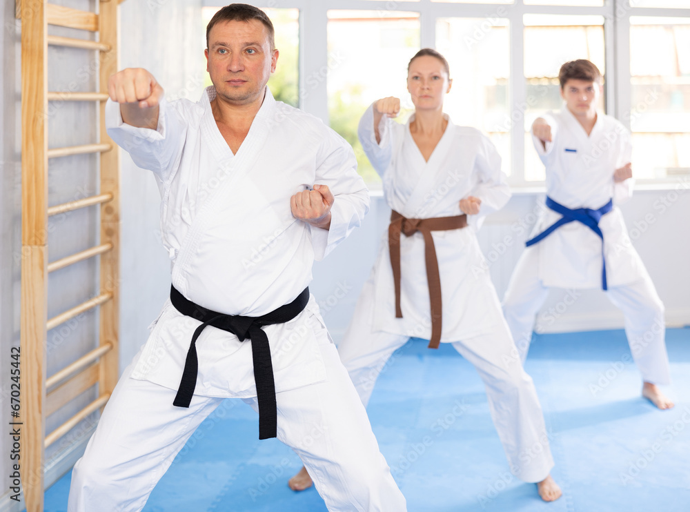 Three athletes have taken starting position and studying and repeating ...