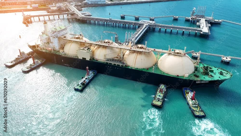 LNG (Liquefied natural gas) tanker anchored in Gas terminal gas tanks ...
