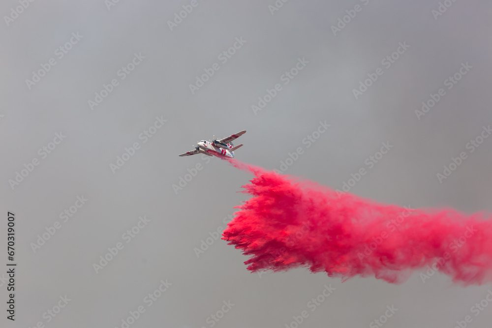 Airplanes dropping phos-check fire retardant on California wild fires ...
