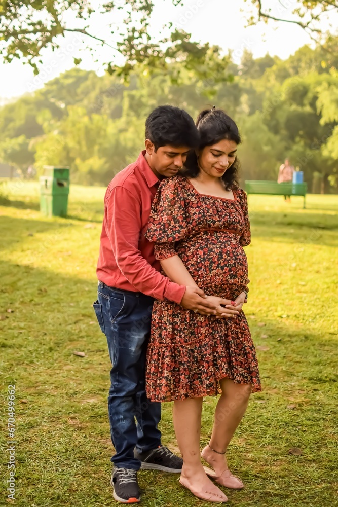 Indian couple posing for Maternity shoot pose for welcoming new born ...