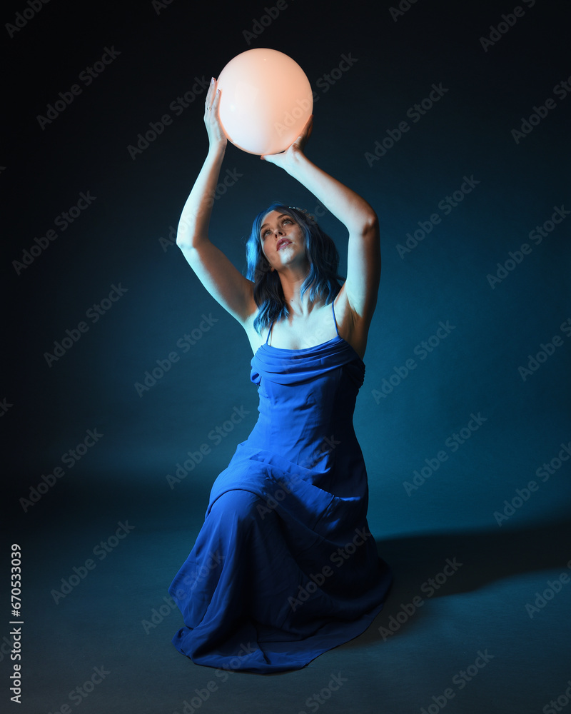 Full length portrait of beautiful female model wit blue hair wearing ...