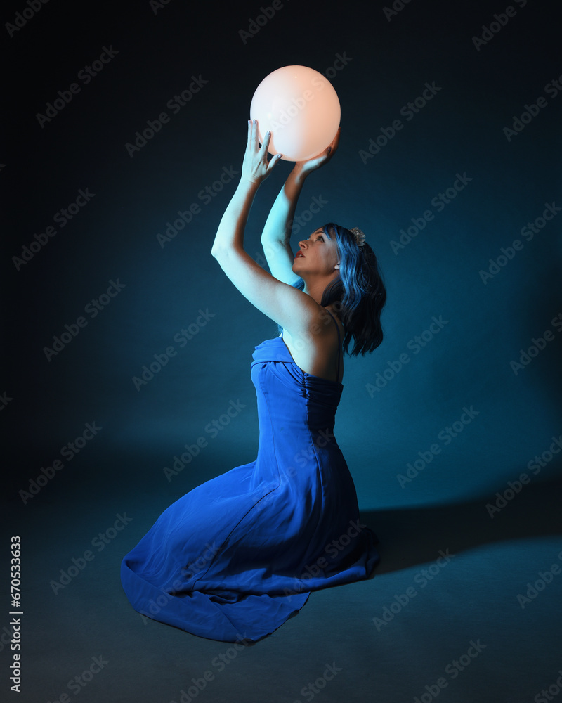 Full length portrait of beautiful female model wit blue hair wearing ...