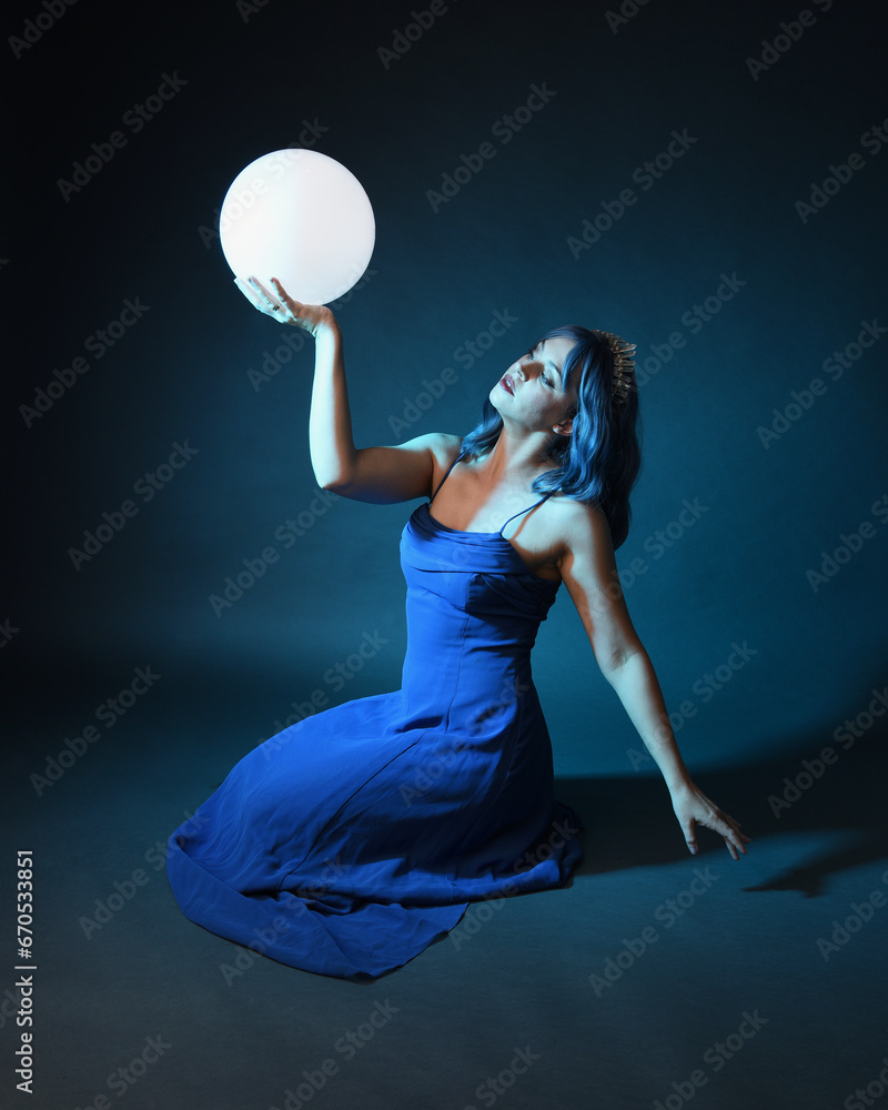 Full length portrait of beautiful female model wit blue hair wearing ...