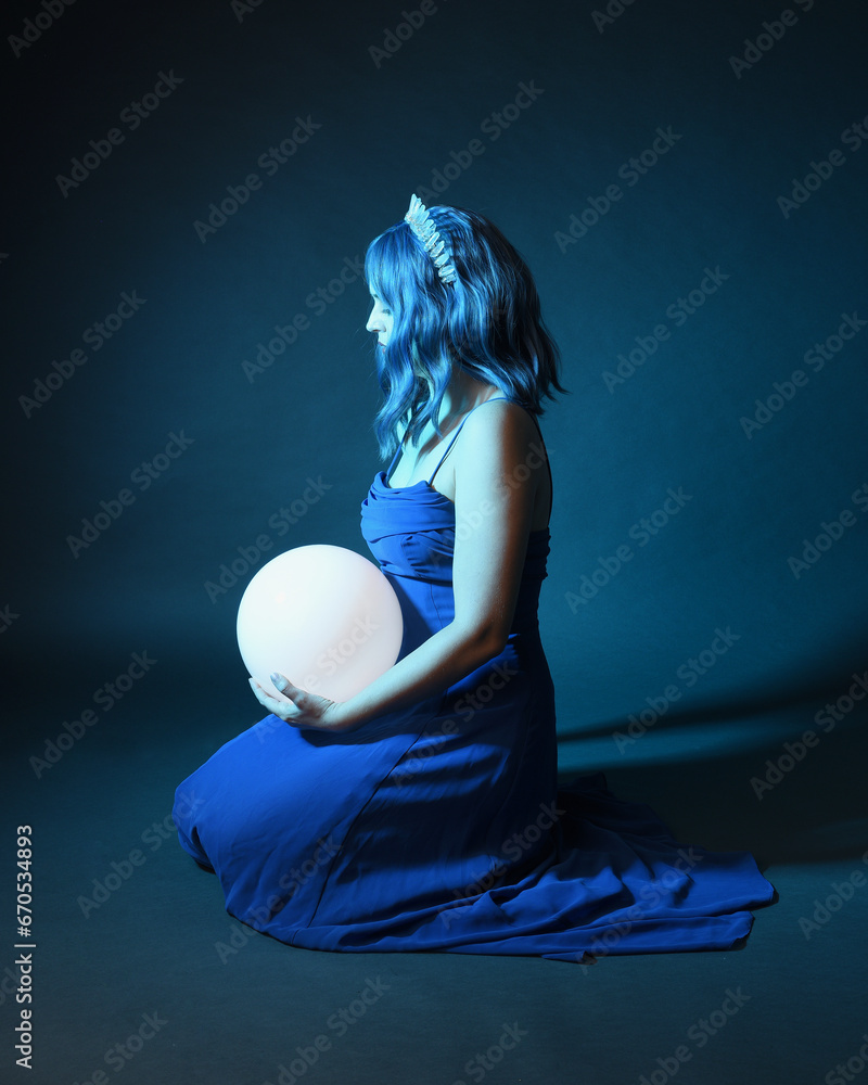Full length portrait of beautiful female model wit blue hair wearing ...