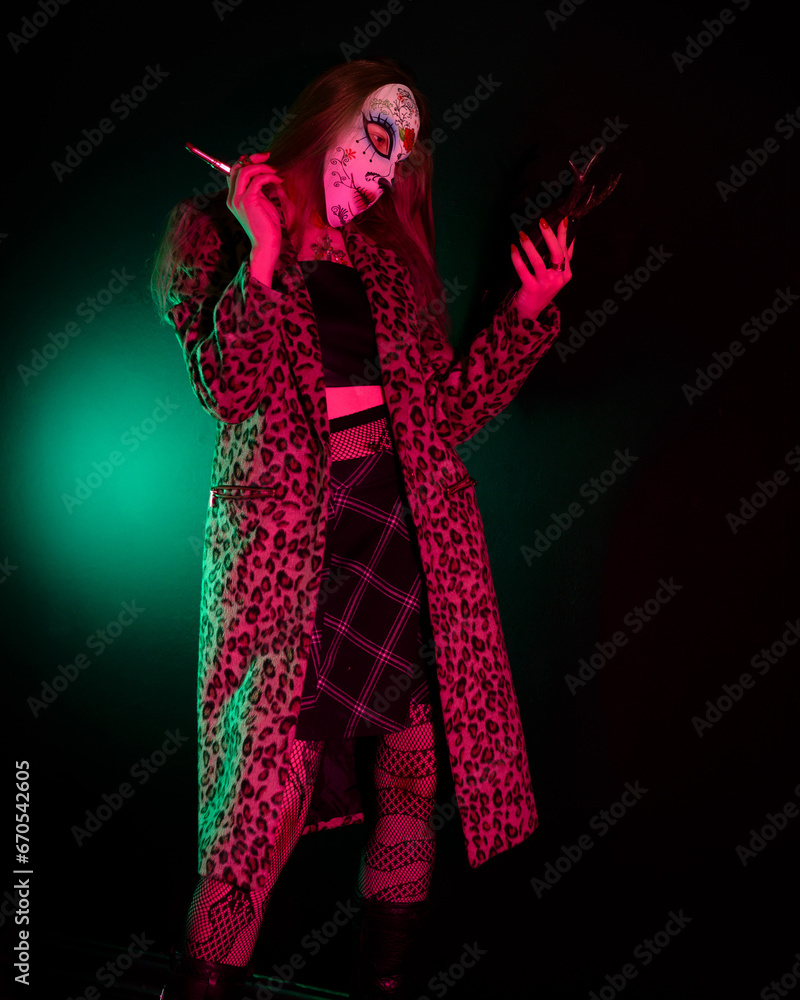 A fashion-forward woman with masquerade mask poses in a leopard print ...