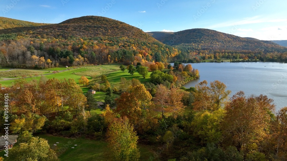 Mountain, trees and fields in sunny landscape with campground and ...