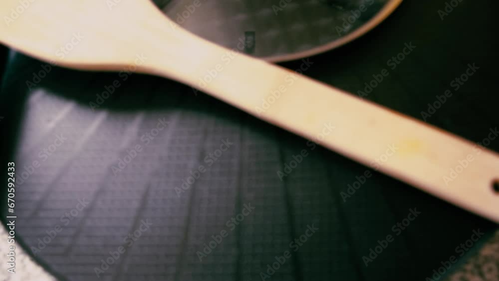 Cinematic close up of an electric shabu pan or an electric griddle with ...