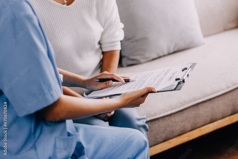 Serious GP doctor showing tablet screen to old 70s female patient ...
