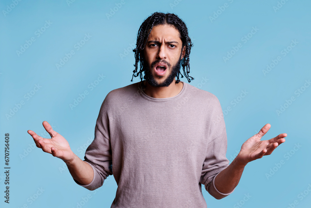 Angry arab man with open arms and confused facial expression portrait ...