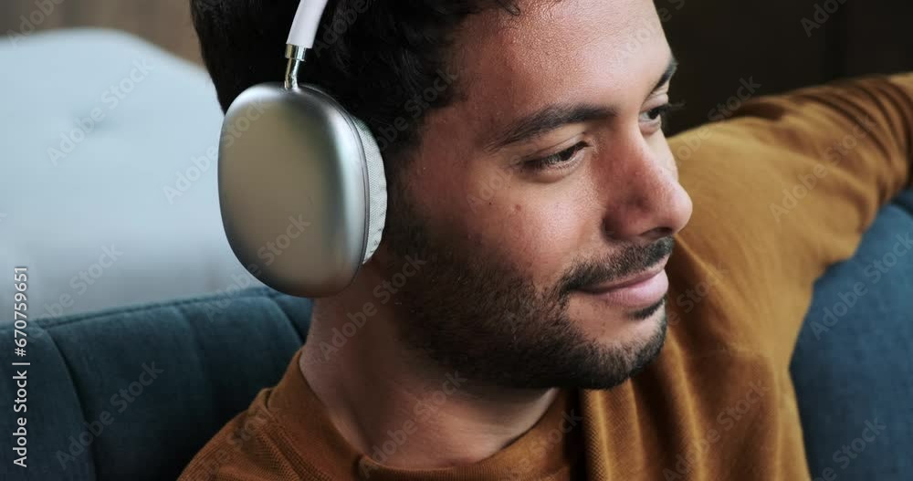 Dejected man occupies a spot on the living room sofa, his downcast ...