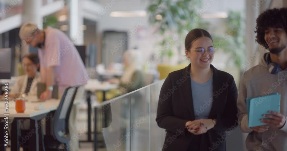A diverse group of colleagues exchange business experiences, engage in ...