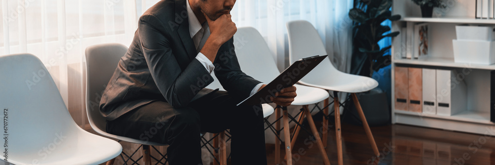 Job applicant waiting for interview in waiting room alone with empty ...