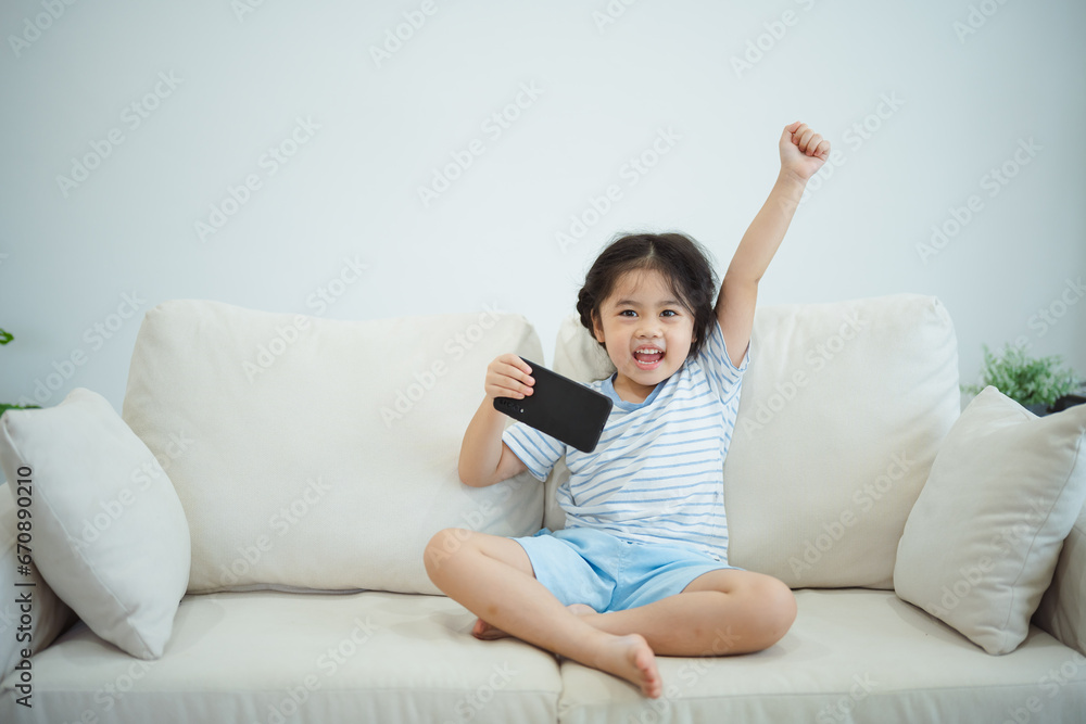 Asian child girl raise your hand cheerful success looking using and ...