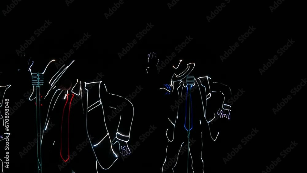 Light LED dance show. dancers in costumes with LED strip dancing in a ...