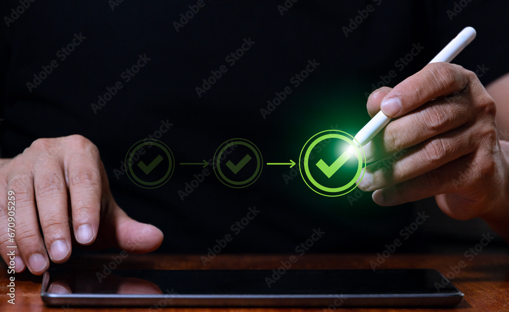 Businessman uses electronic pen to tick correct marks for document ...