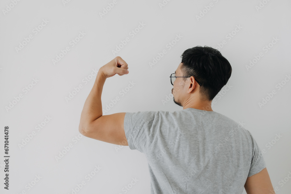 Backside view of Asian man back wear grey t-shirt raising arms, showing ...