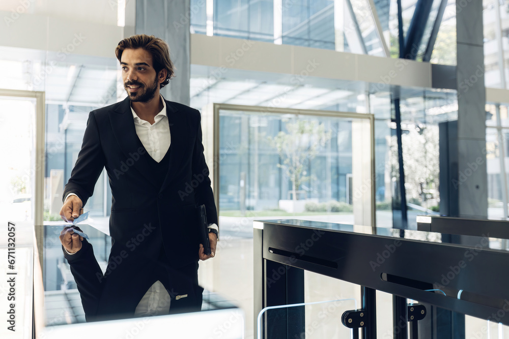 Businessman using card to open automatic gate machine in office ...