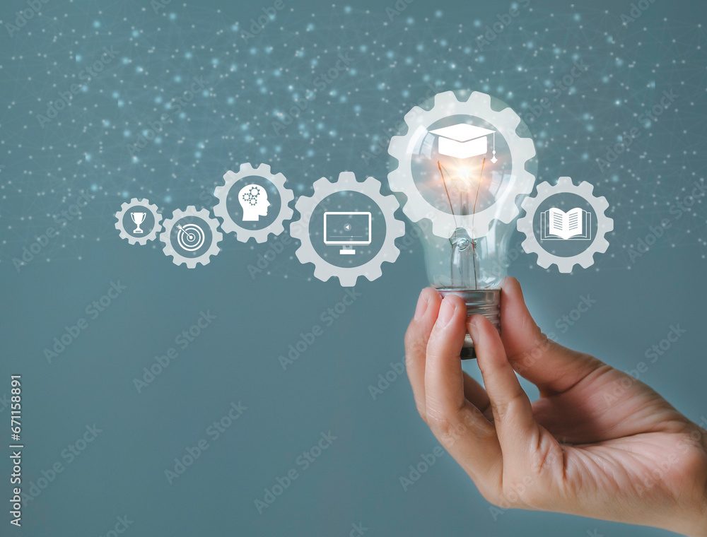 Hand holding a light bulb showing a graduation cap Achievements and ...