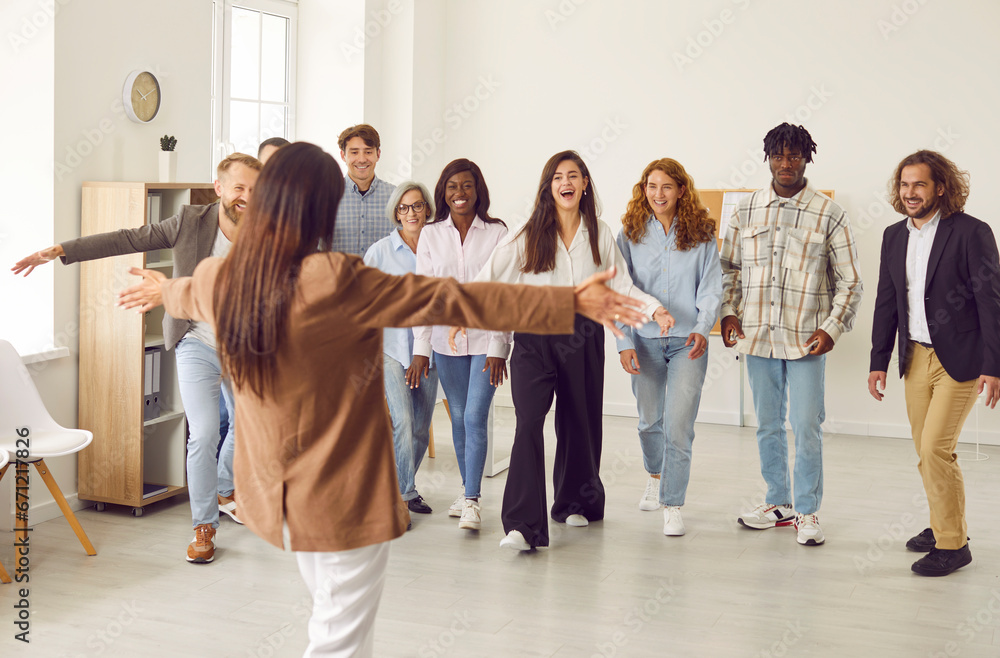 Woman standing back opened her arms greeting friends at home or ...