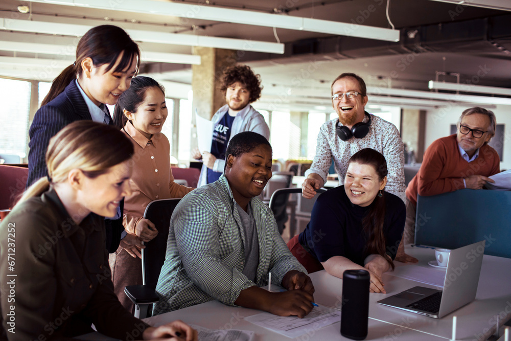 Diverse group of colleagues collaboratively working on a project in a ...