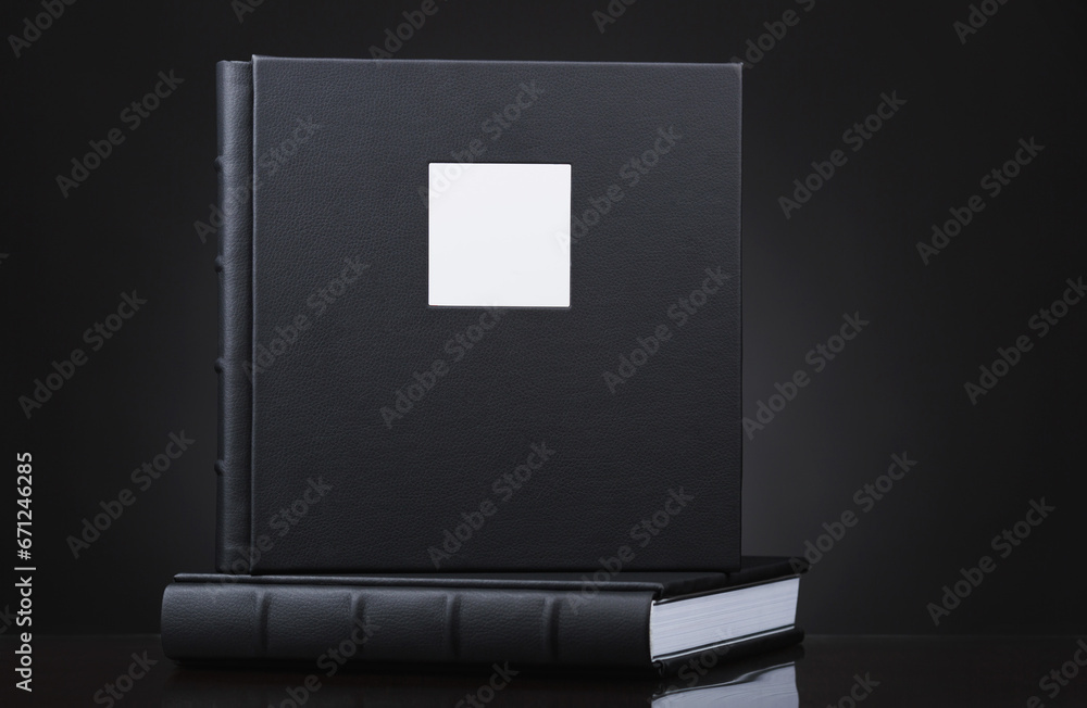 A beautiful leather bound books against a black background. Wedding ...