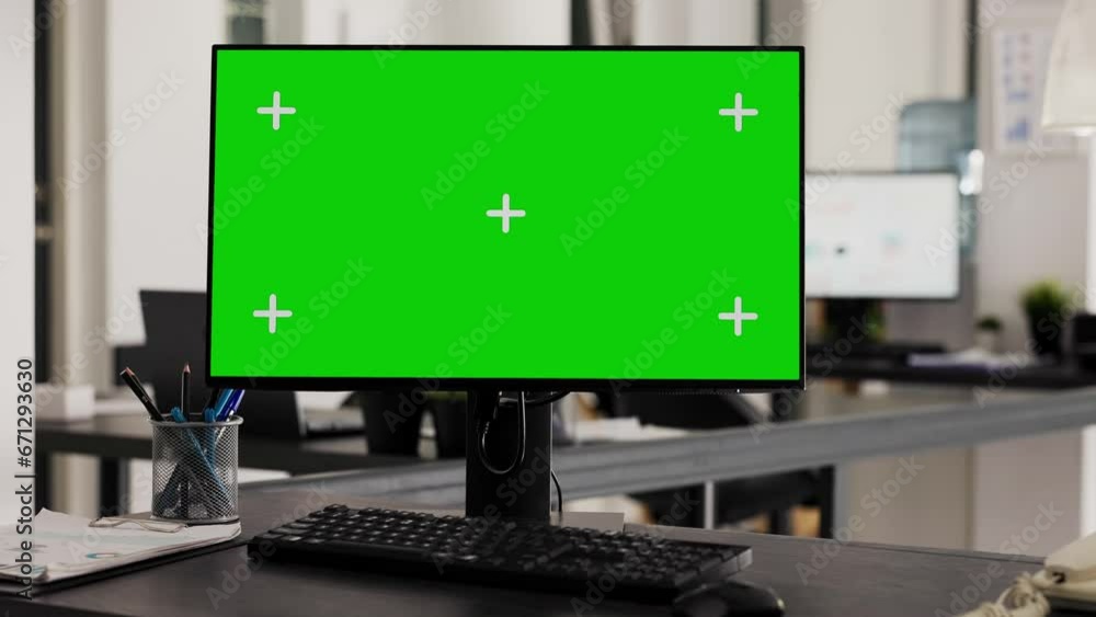 Greenscreen on office workstation placed in creative agency space ...