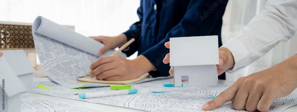 Worker, architect and engineer work on real estate construction project ...