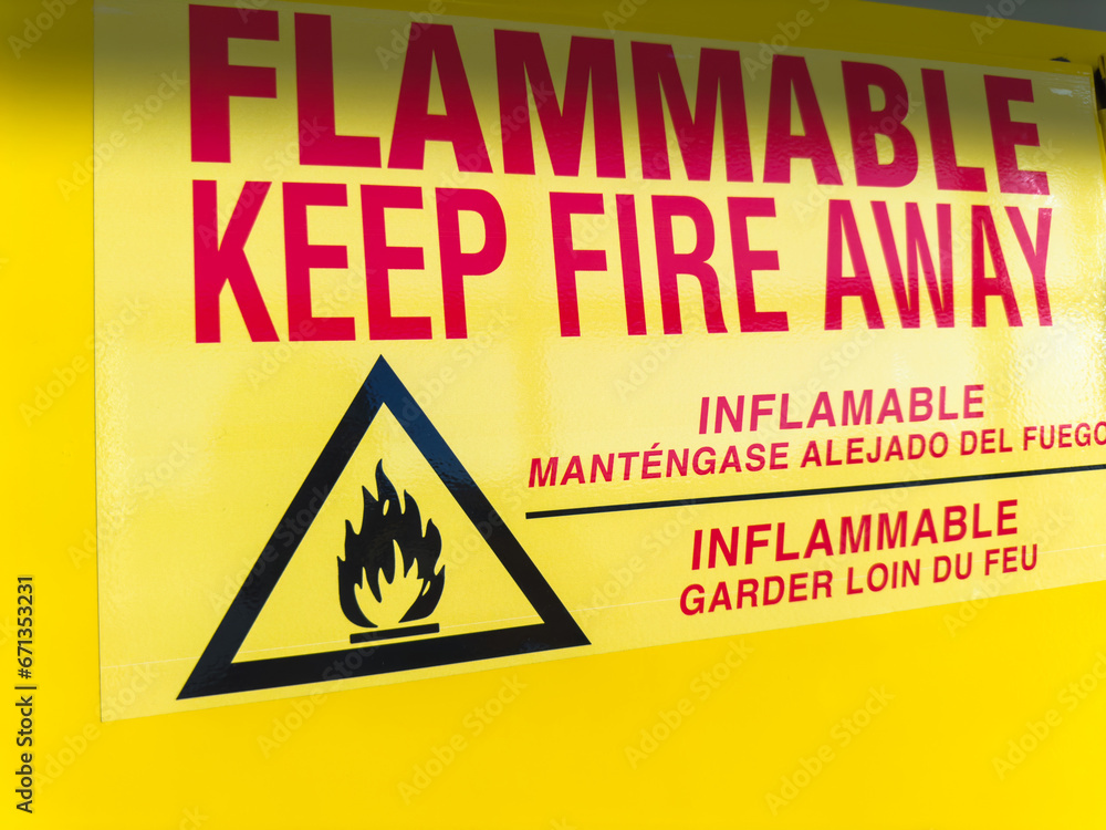 caution sign stands tall against a backdrop of hard hats and heavy ...