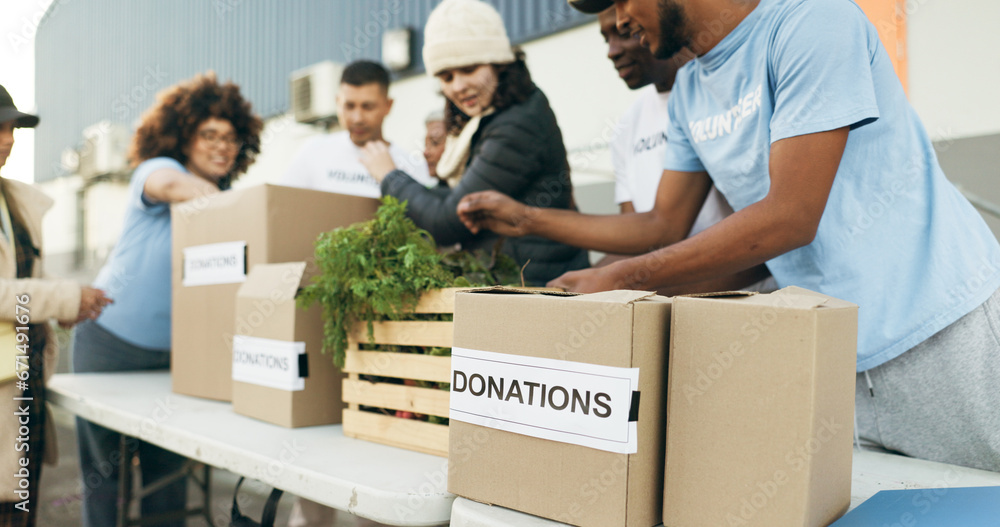 Teamwork, people volunteering and food boxes on table for charity event ...