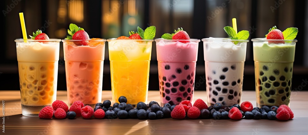 Variety of fresh bubble tea with strawberries raspberries grapes ...