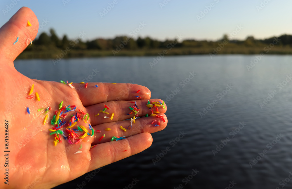 Microplastics on hand from lake. Micro waste in water fauna ...