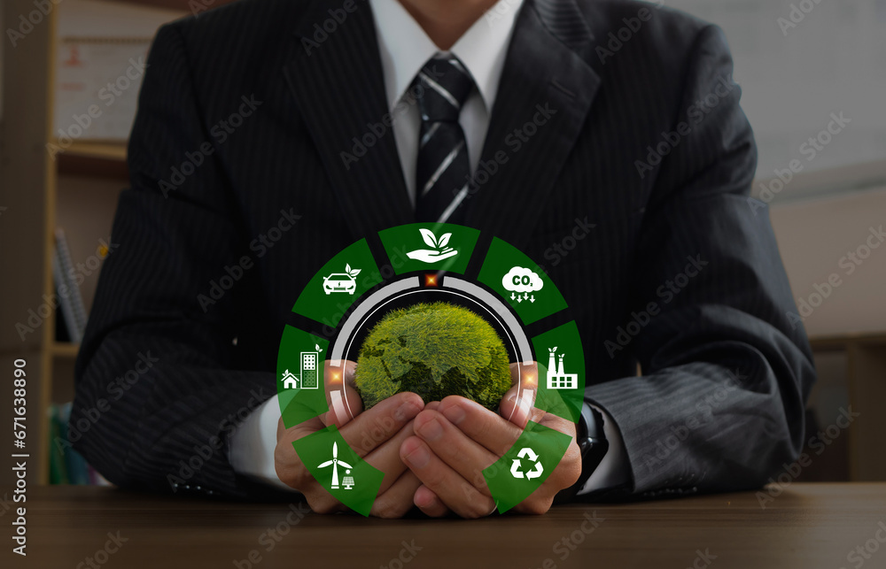 Businessman holding green earth with icons of green business for ESG, co2, and net zero. Concept ...